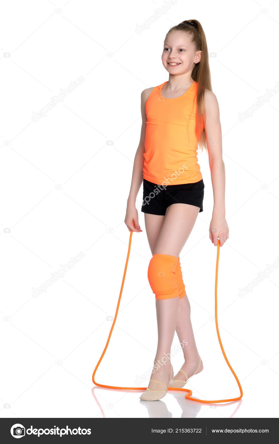 A girl gymnast performs exercises with a skipping rope. Stock Photo by ...