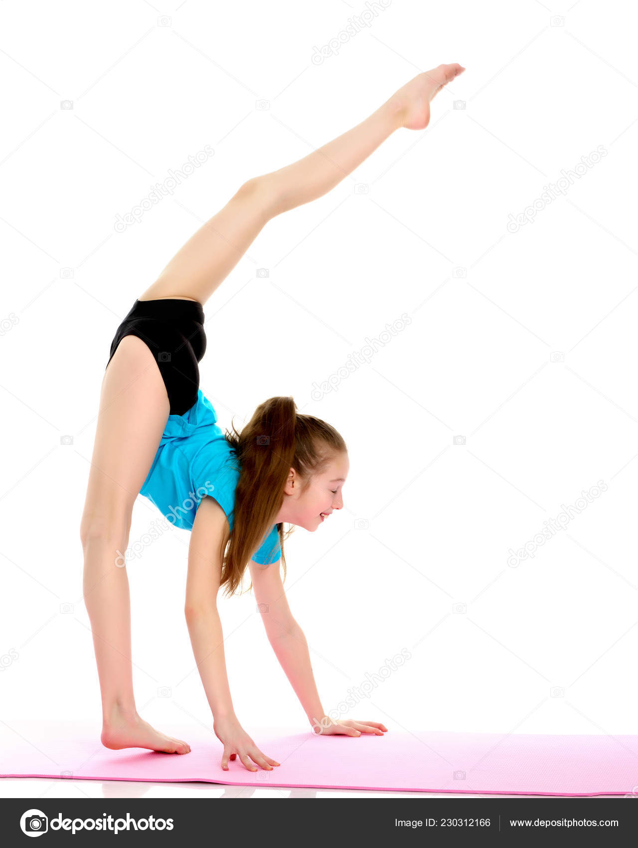 The little gymnast perform an acrobatic element on the floor. Stock ...