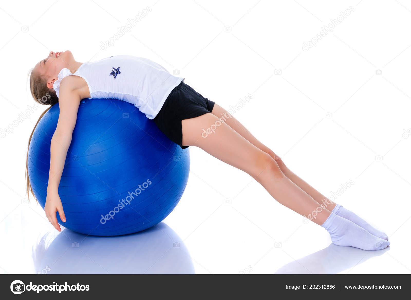 Little girl doing exercises on a big ball for fitness. Stock Photo by ...