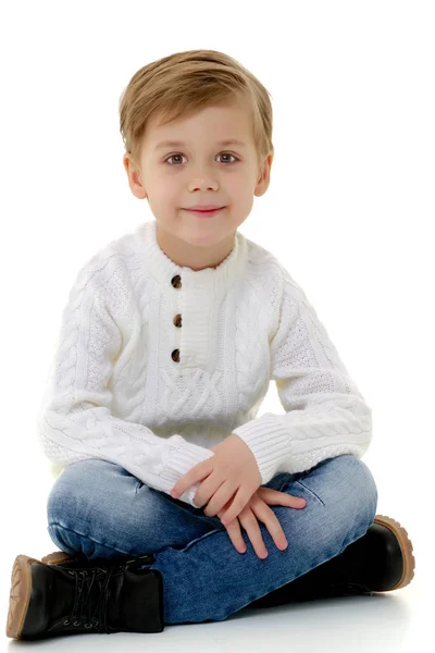 A little boy is sitting on a chair. Stock Photo by ©lotosfoto1 266073884