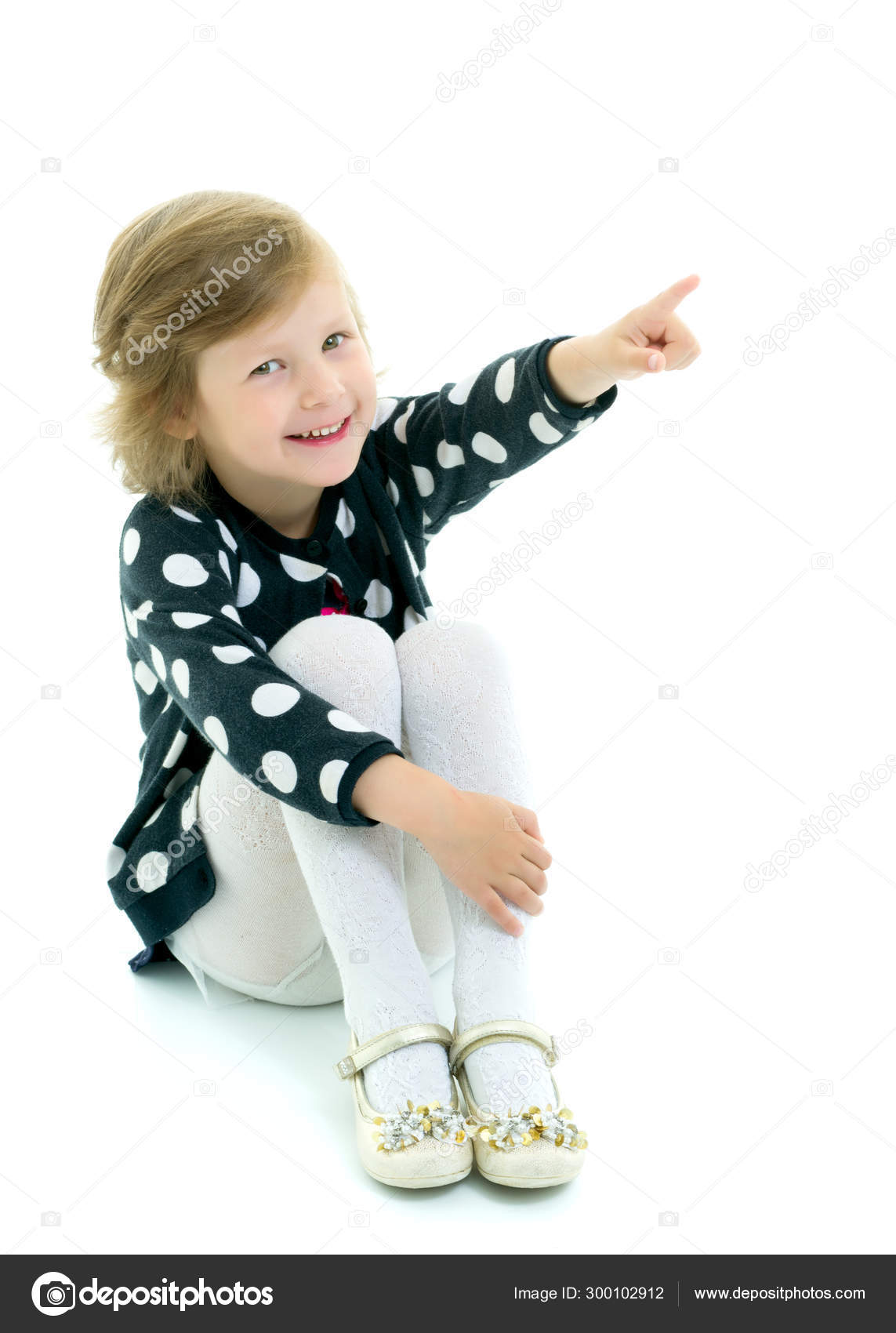 Little girl points with a finger Stock Photo by ©lotosfoto1 300102912