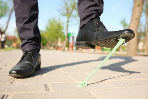 Man stepping in chewing gum on sidewalk. Concept of stickiness - Stock ...