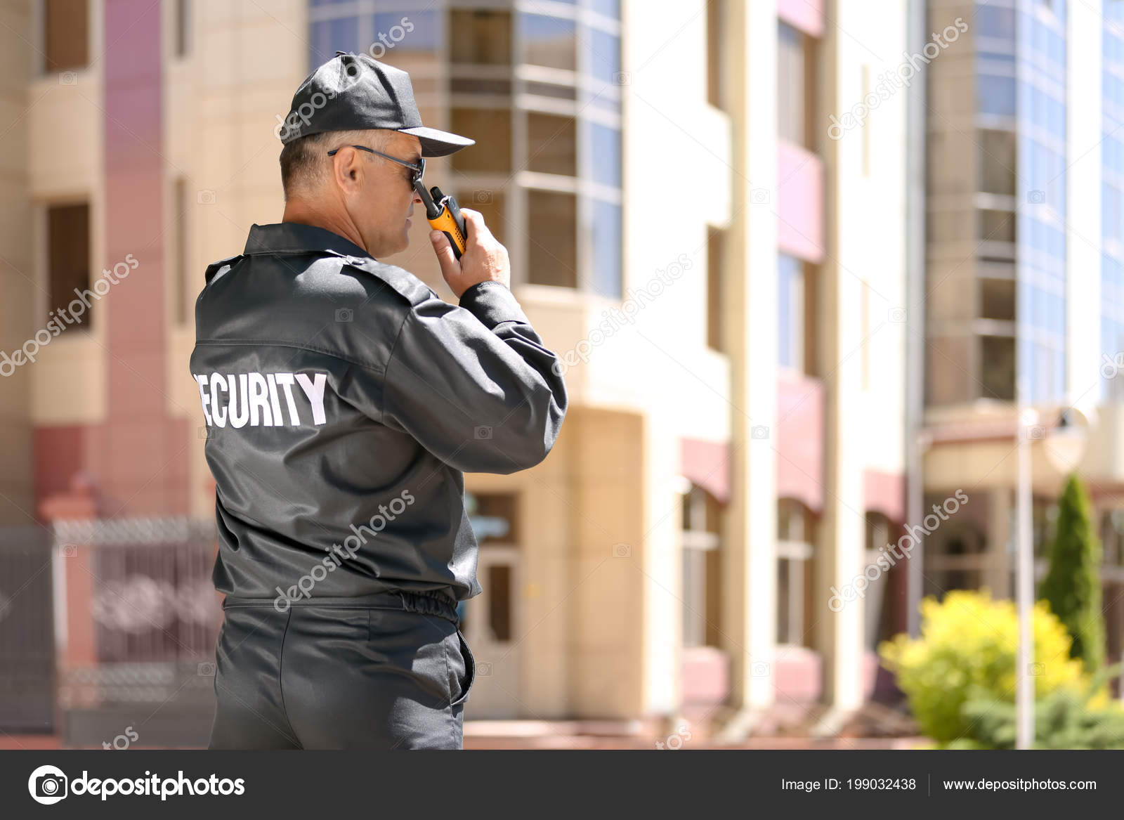 Male Security Guard Using Portable Radio Transmitter Outdoors Stock ...