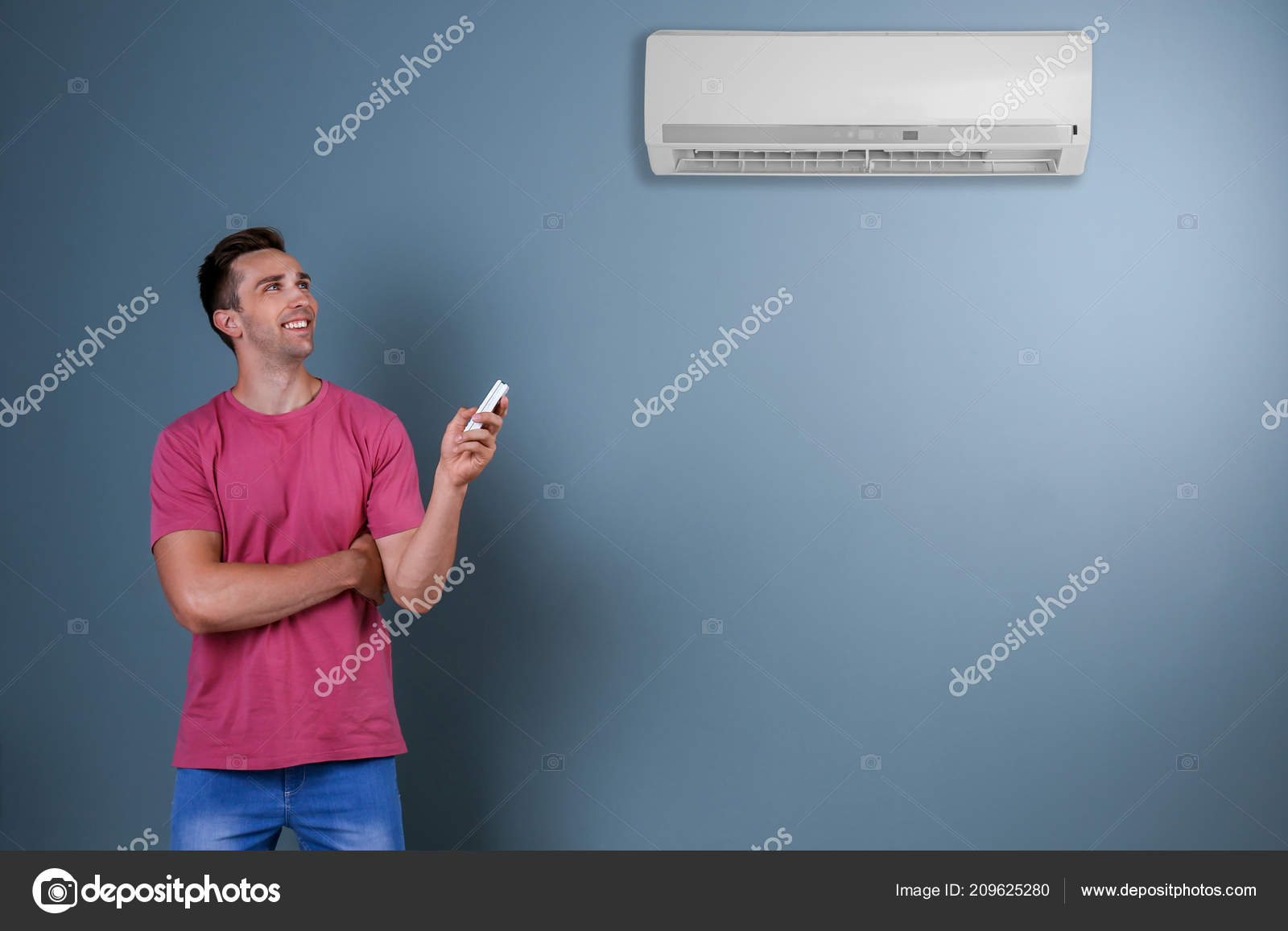 Young Man Operating Air Conditioner Color Background Stock Photo by ...
