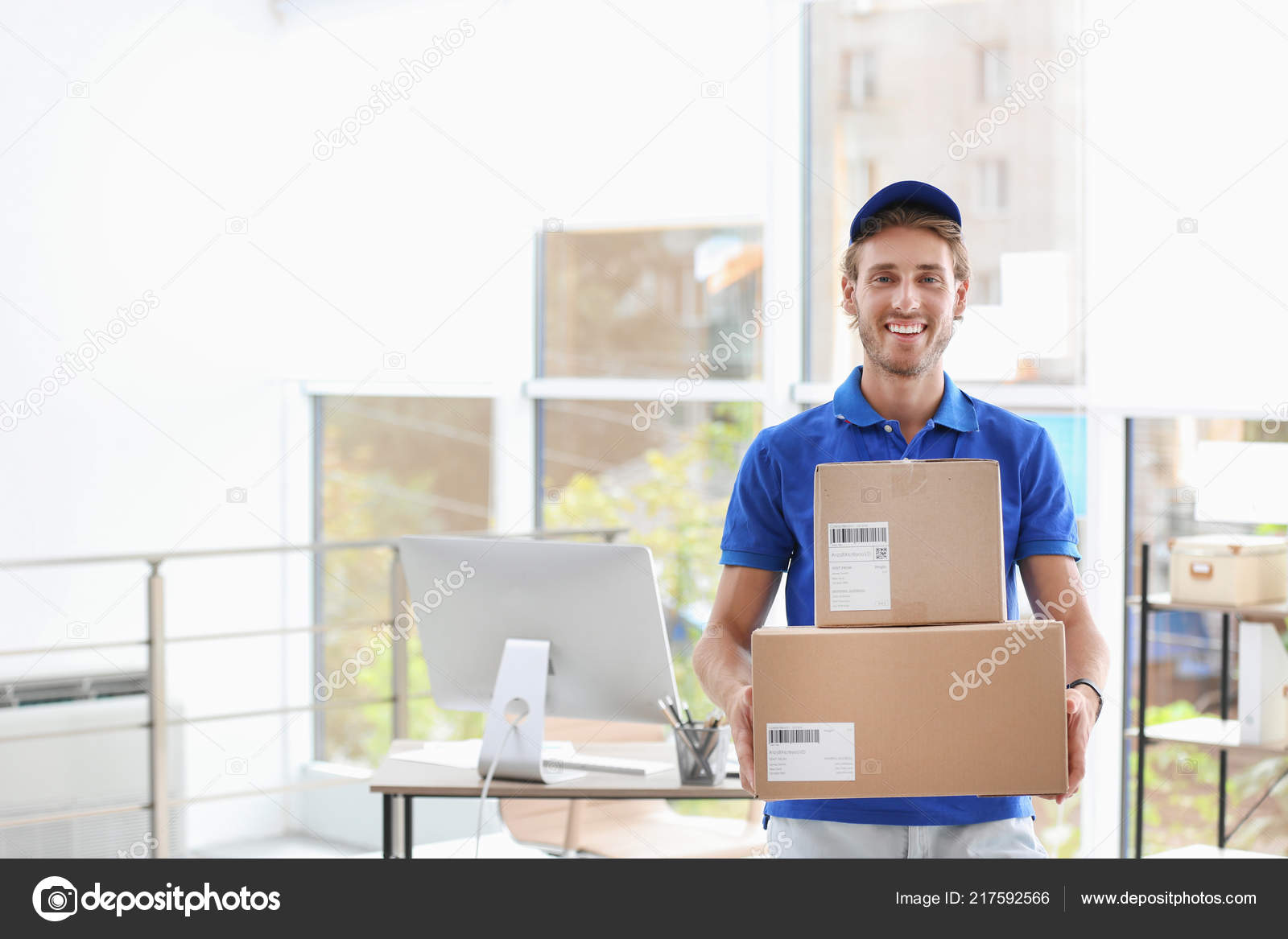 Young Courier Standing Parcels Office Desk Space Text Stock Photo by ...