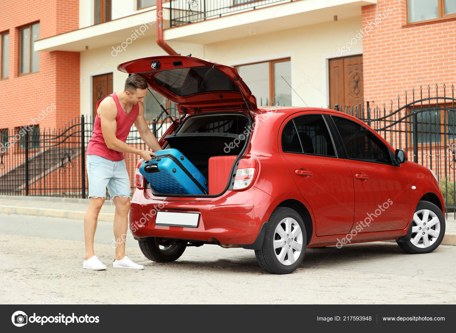 Man Packing Suitcase Car Trunk City Street — Stock Photo © NewAfrica ...