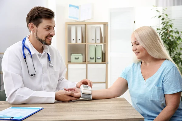 Doctor Checking Mature Woman's Pulse Medical Device Hospital Closeup ...