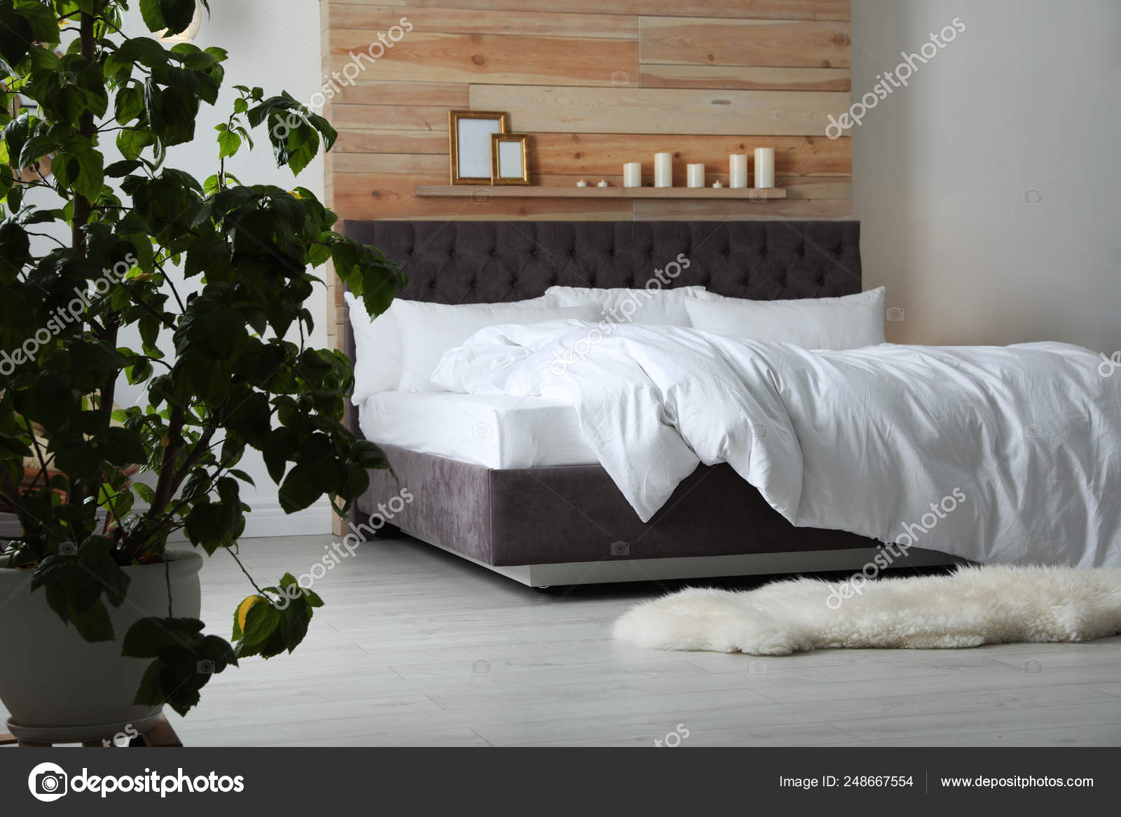Large comfortable bed in stylish room. Modern interior design — Stock ...