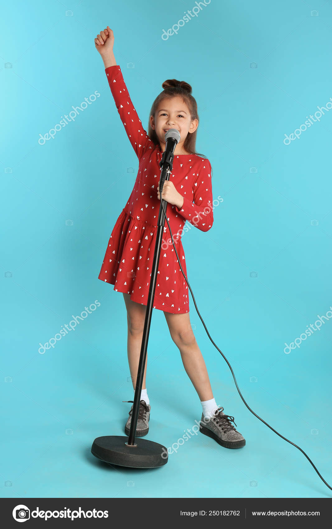 Cute funny girl with microphone on color background Stock Photo by ...