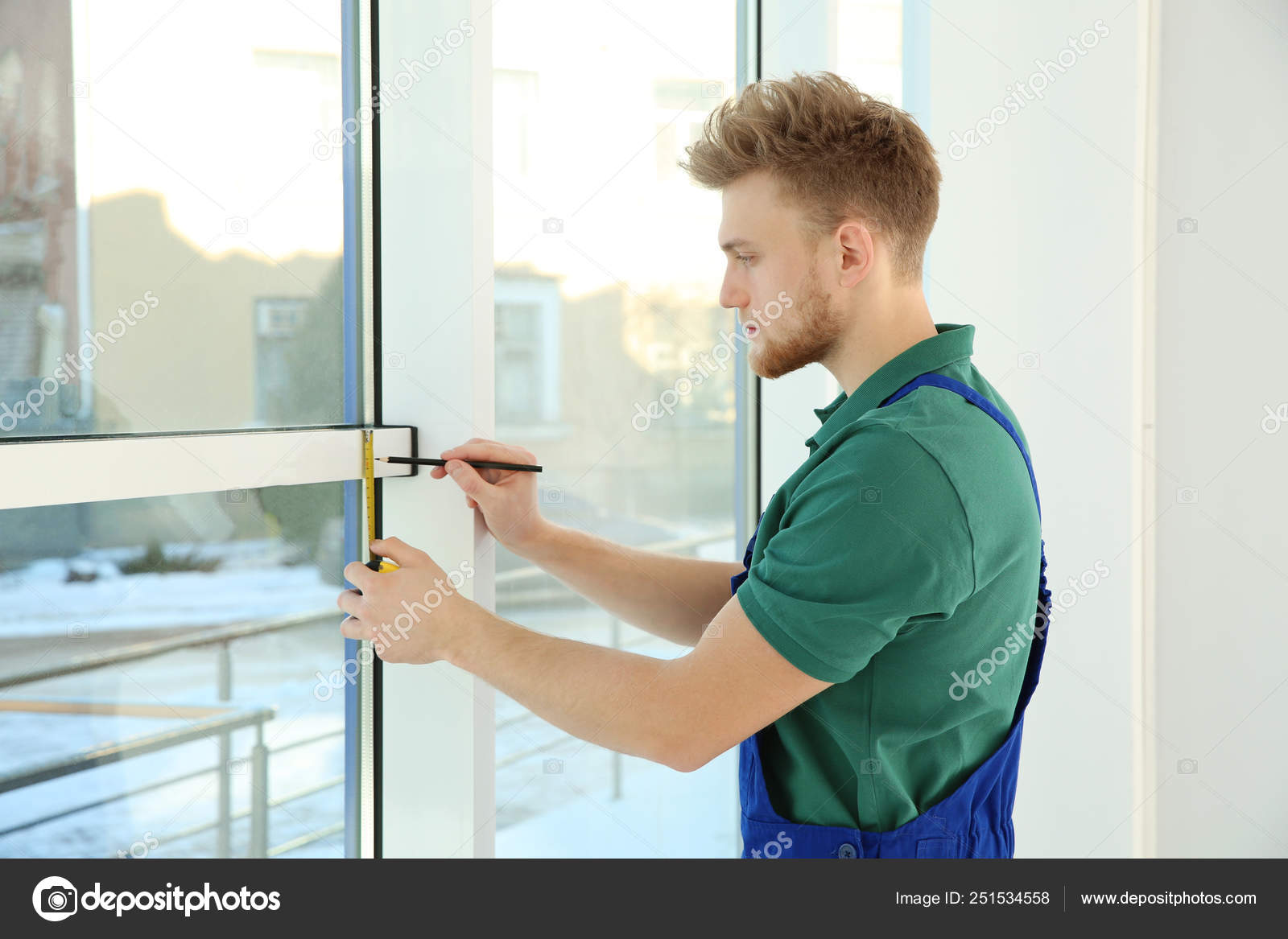 Service man measuring window for installation indoors Stock Photo by ...