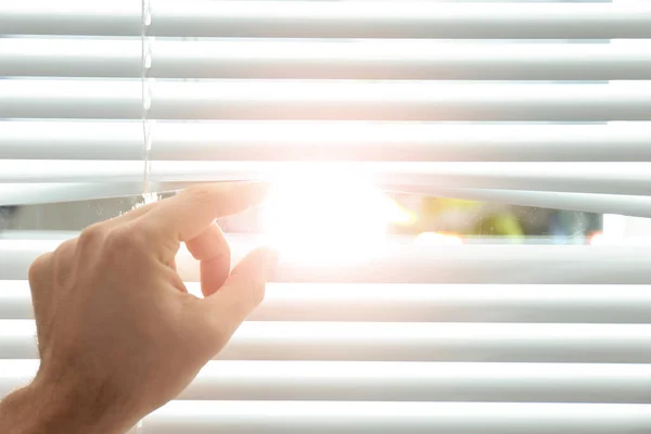 Young man opening window blinds, closeup. Space for text - Stock Image ...