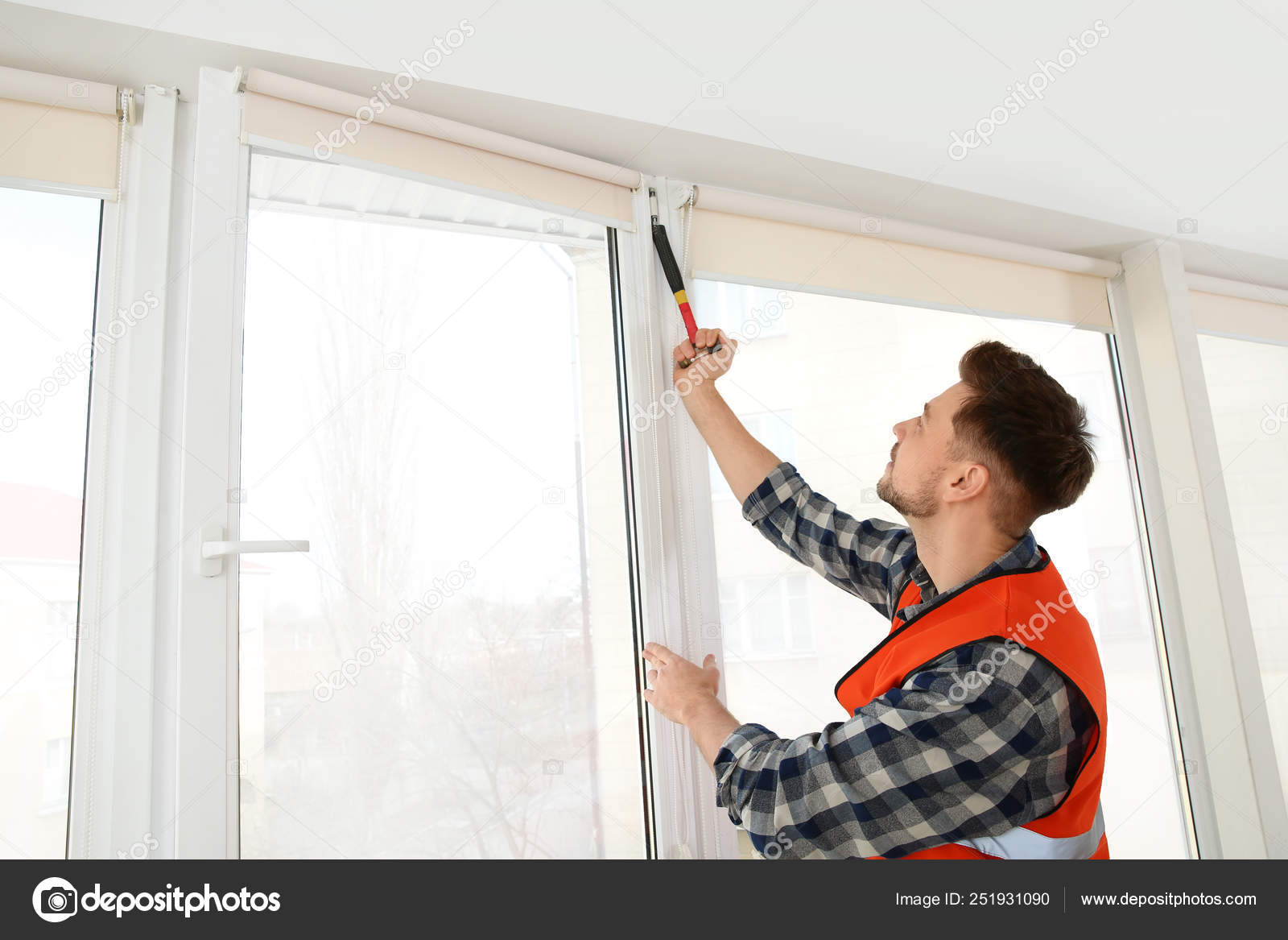 Construction worker installing plastic window in house Stock Photo by ...