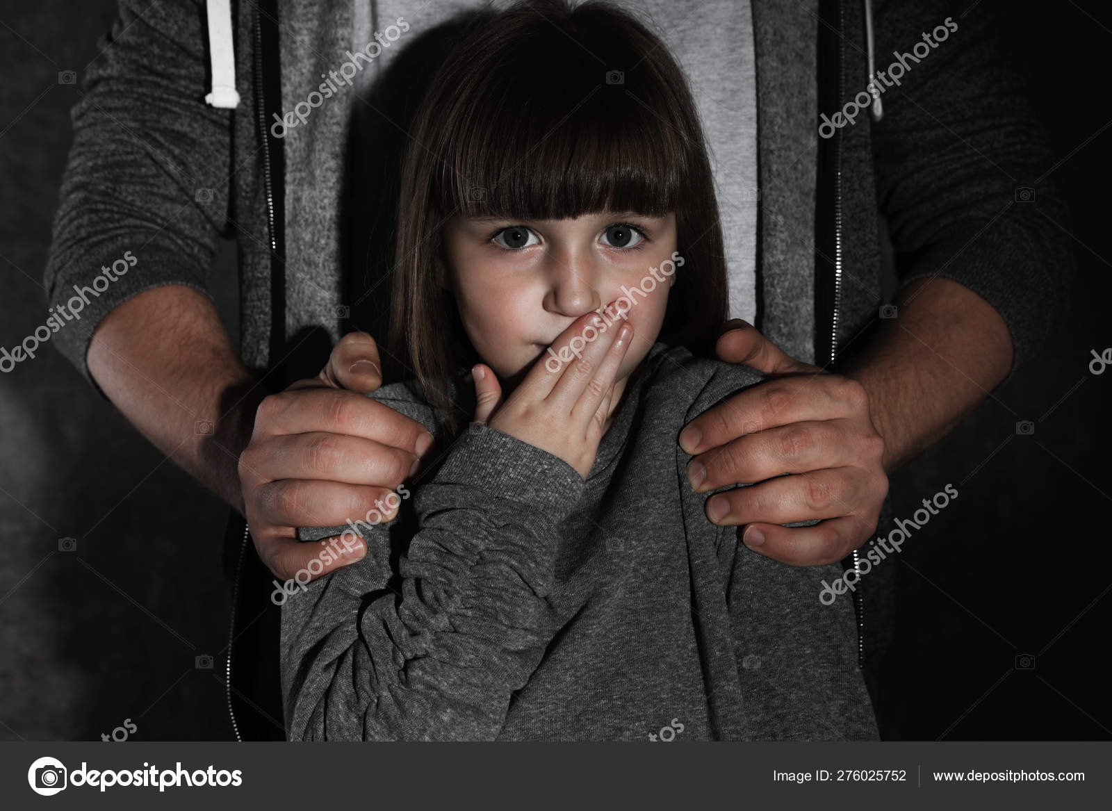 Scared little girl and adult man on dark background. Child in danger ... Scared little girl and adult man on dark background. Child in danger ...