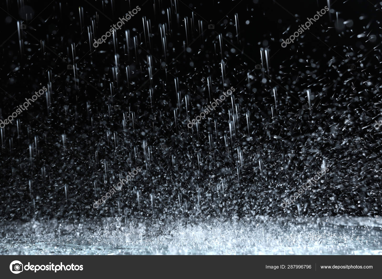 Heavy rain falling down on ground against dark background Stock Photo ...