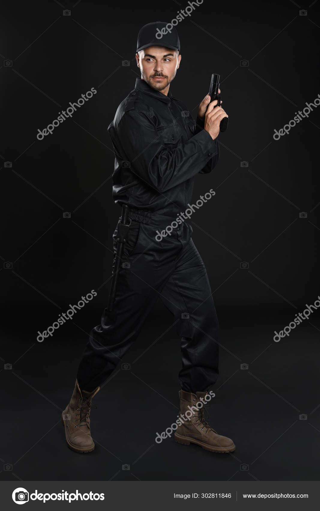 Male security guard in uniform with gun on dark background — Stock ...