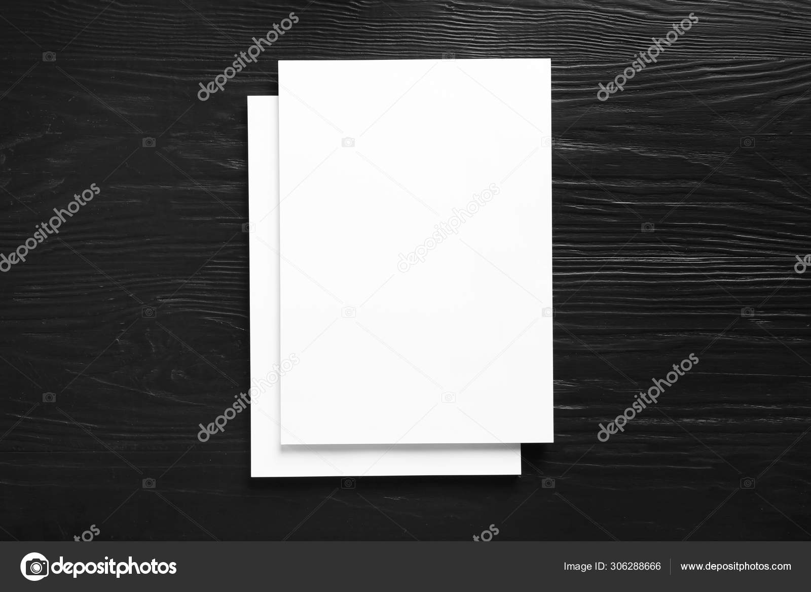 Stack of blank paper sheets for brochure on black wooden background ...