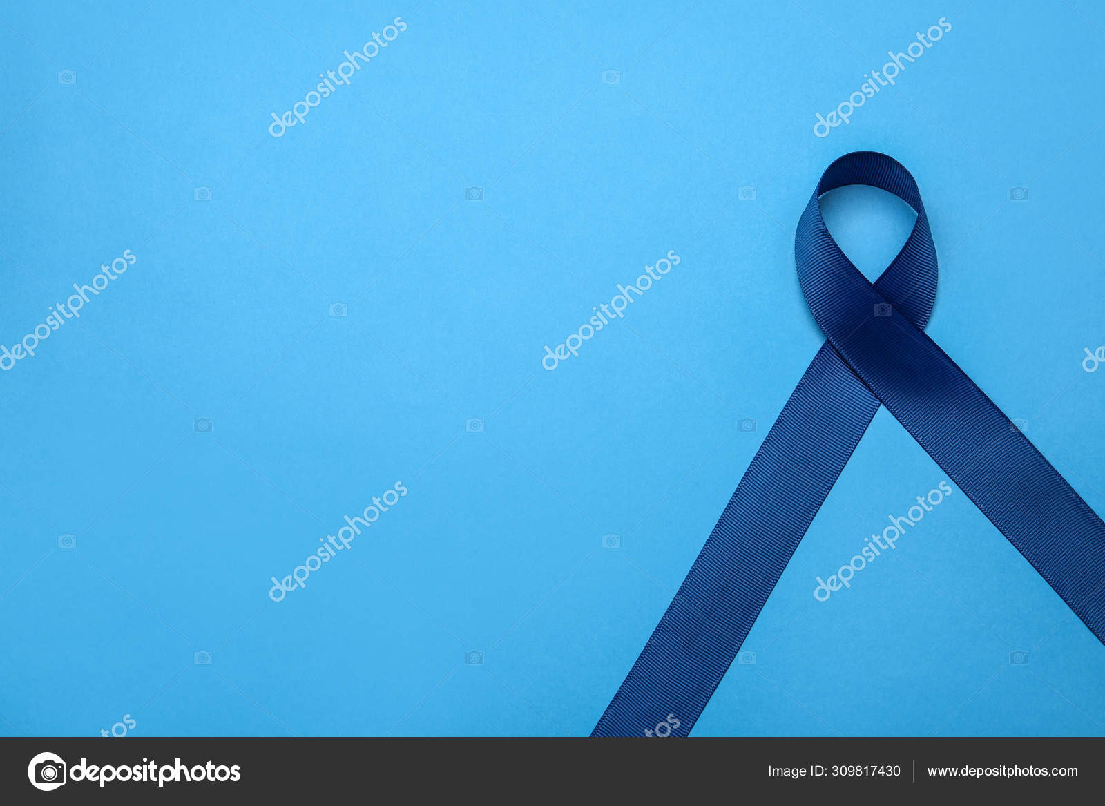 Blue awareness ribbon on color background, top view with space for text ...
