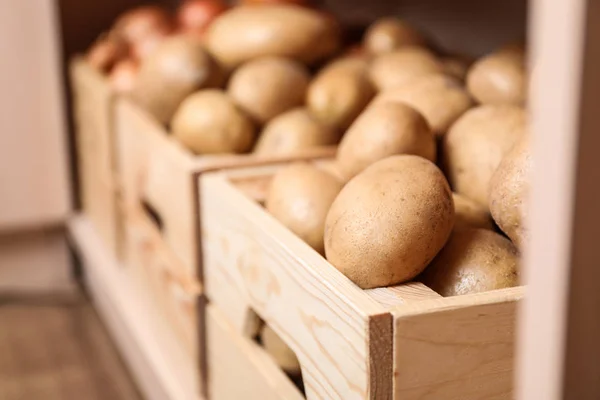 Open drawer with potatoes and onions, closeup. Orderly storage Stock ...