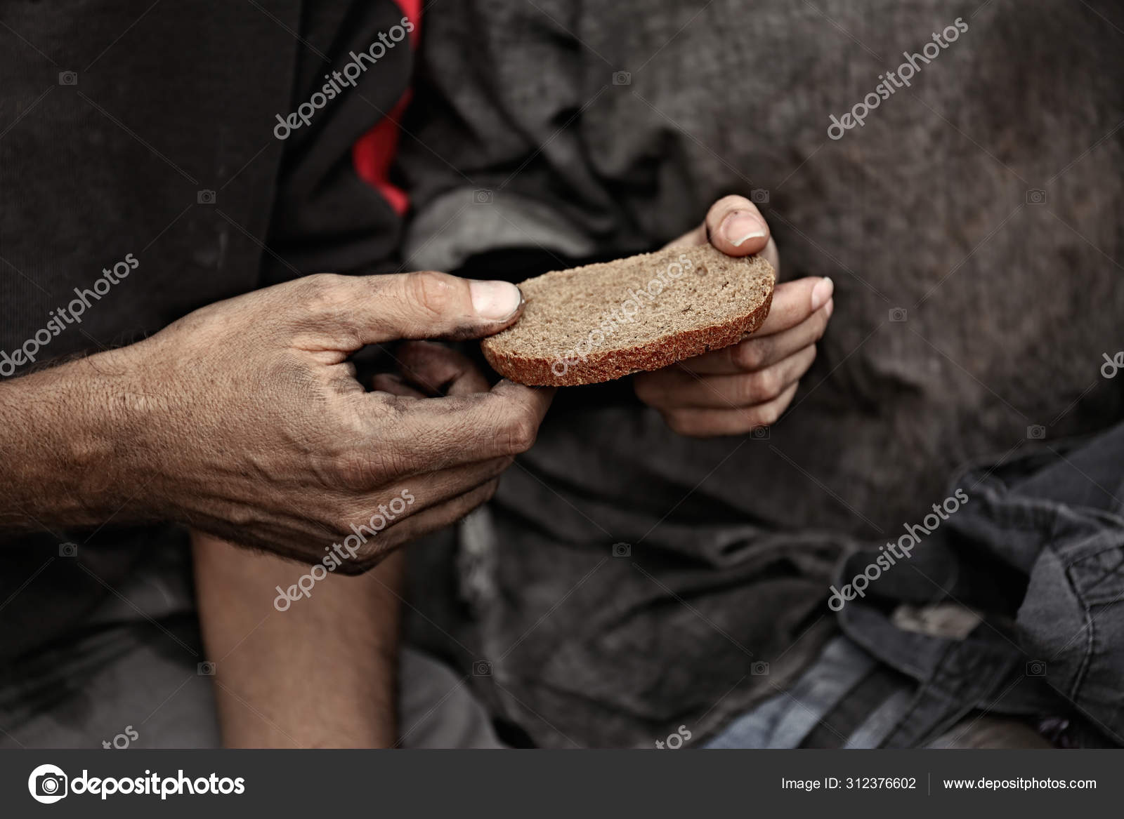 Poor homeless people sharing piece of bread outdoors, closeup Stock ...