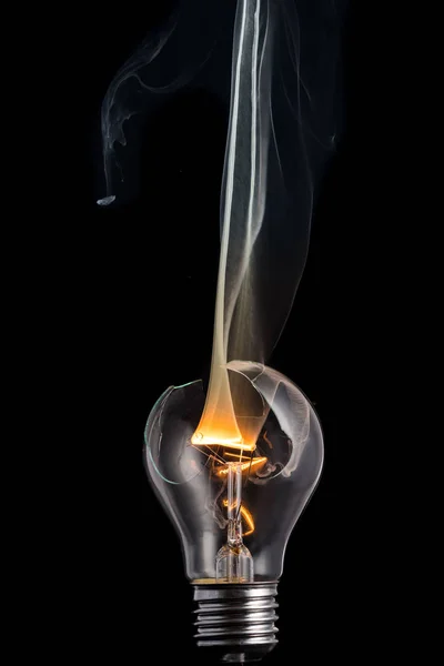 Fire and smoke inside the light bulb — Stock Photo © somchaij #31426061