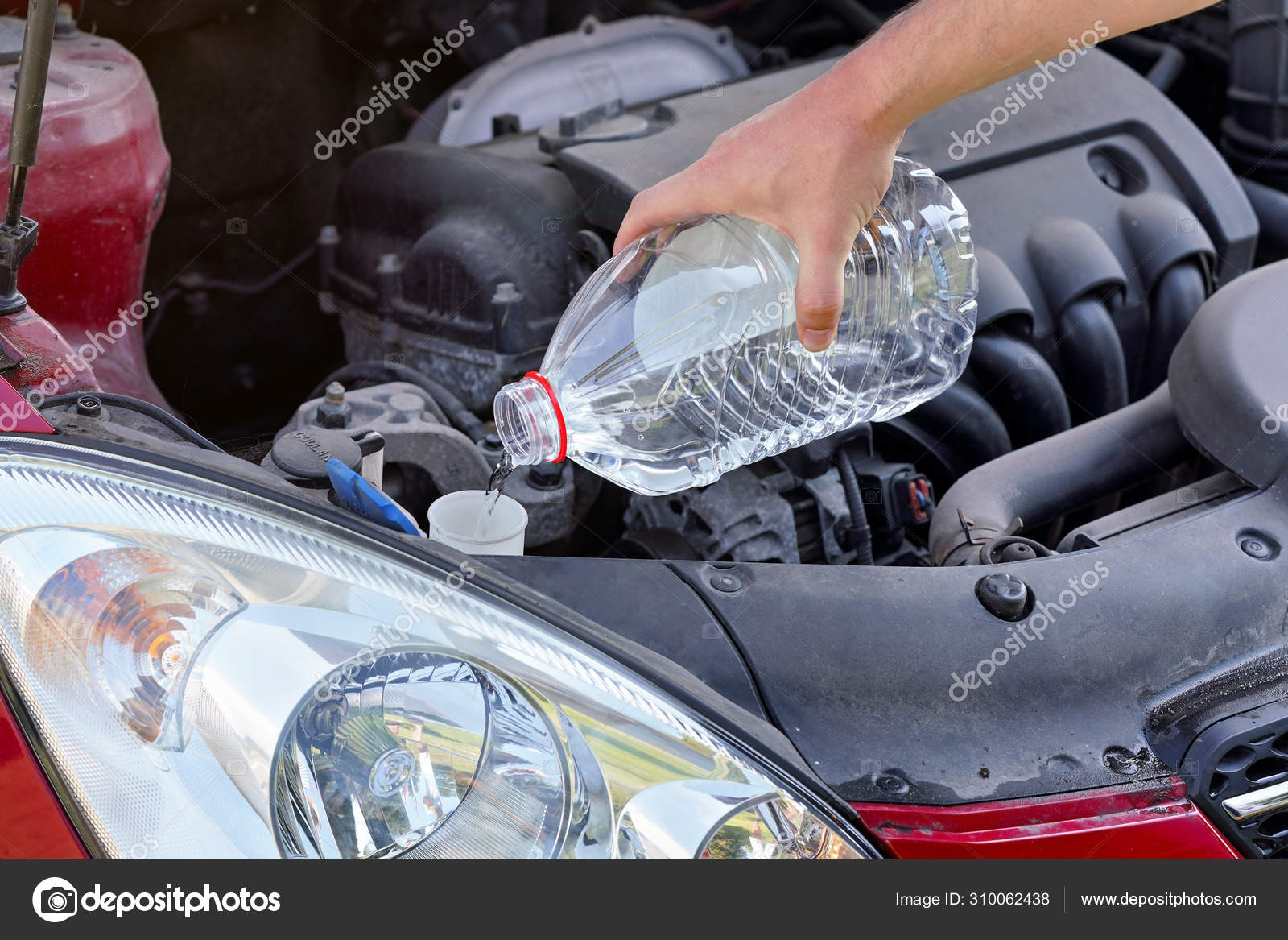Man pouring distilled water ecological alternative to washing fluid to ...