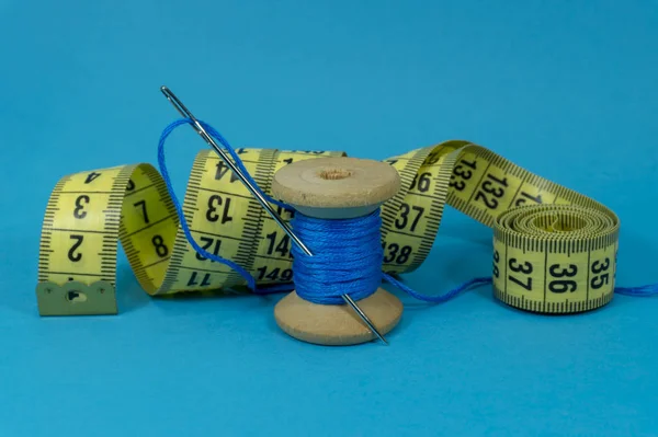 Blue thread, tape measure and sewing needle - Stock Image - Everypixel