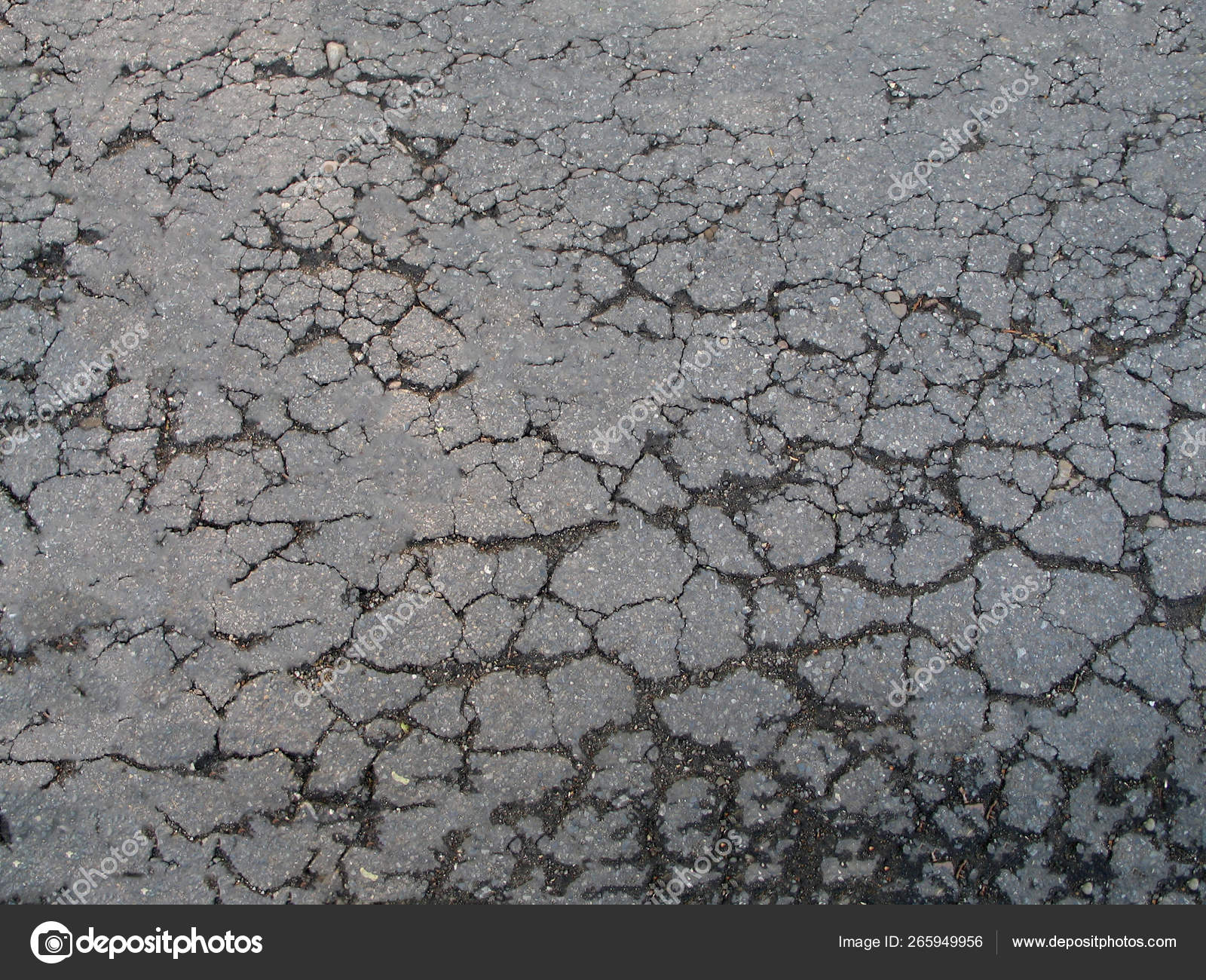 The old crumbling asphalt driveway with a textured surface Stock Photo ...