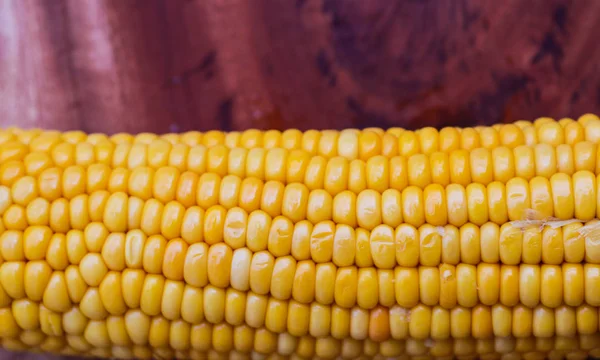 yellow corn stalk close up photo in wooden background - Stock Image ...
