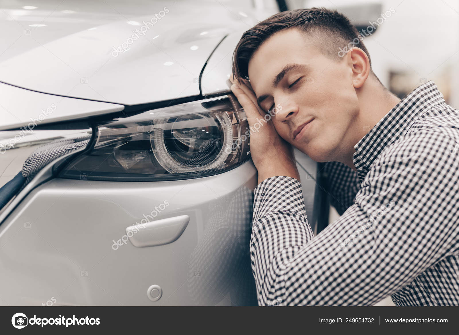 Young man buying new car at the dealership Stock Photo by ©zeroteam13 ...