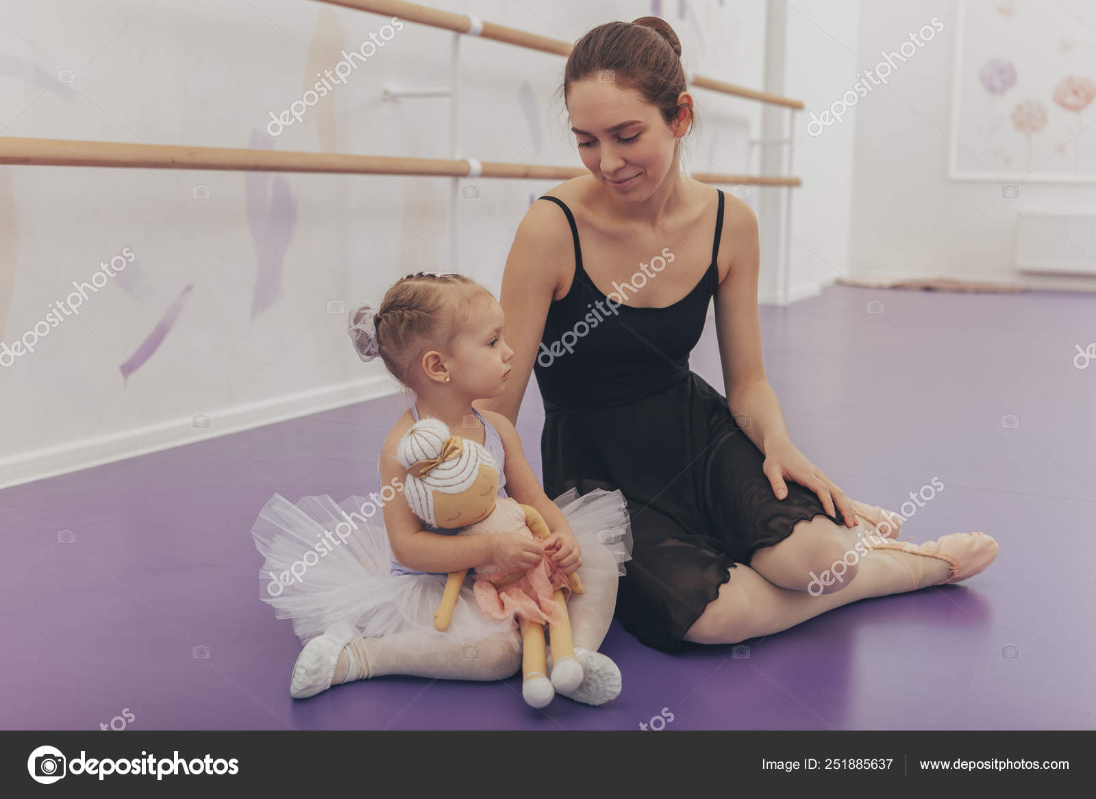 Professional ballerina teaching ballet to her young students Stock ...