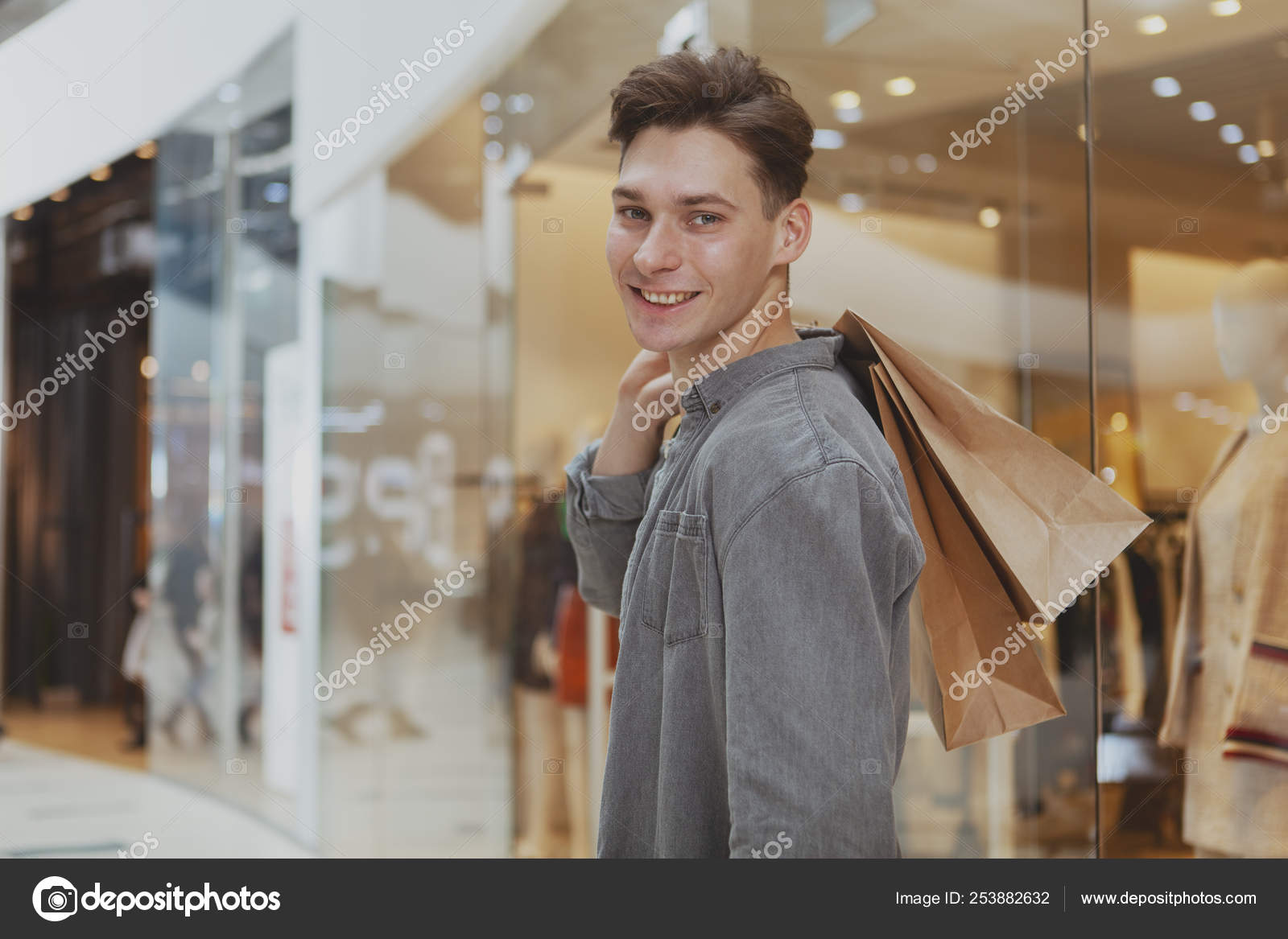 Handsome young man shopping at the mall — Stock Photo © zeroteam13 ...