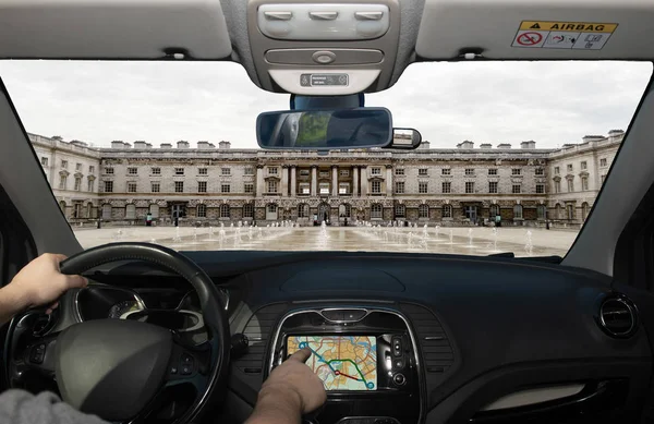 Driving a car while using the touch screen of a GPS navigation system ...