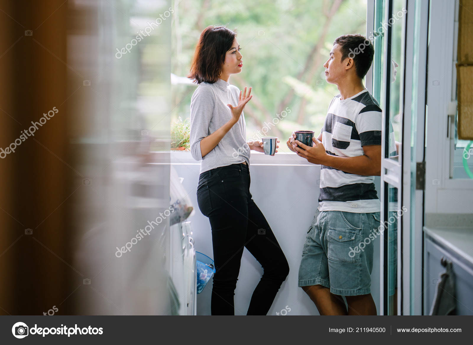 Young Malay Asian Couple Enjoying Hot Drink Talking One Another — Stock Photo © mentatdgt #211940500