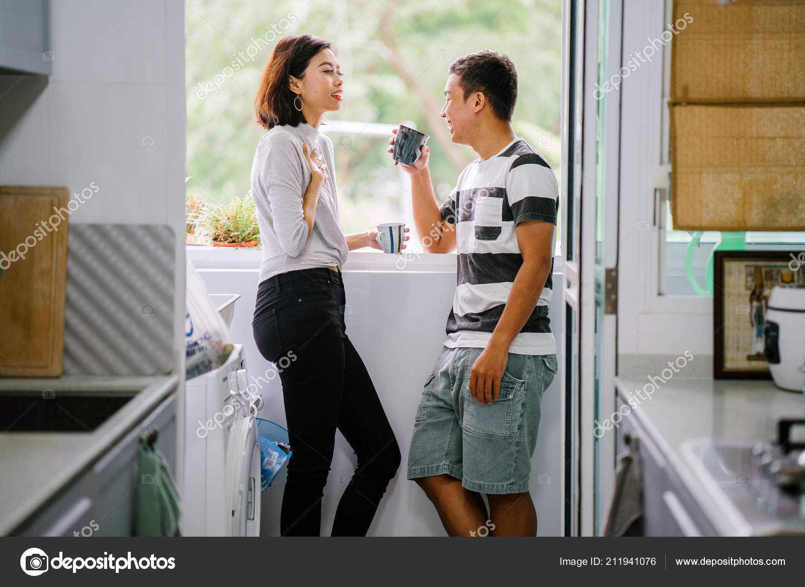 Young Malay Asian Couple Enjoying Hot Drink Talking One Another — Stock Photo © mentatdgt #211941076