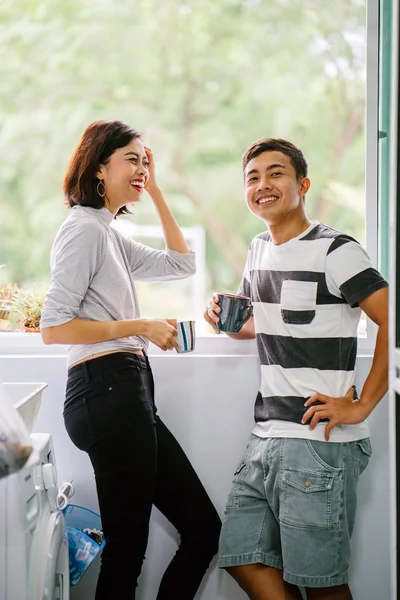 Young Malay Asian Couple Enjoying Hot Drink Talking One Another — Stock Photo © mentatdgt #211940500