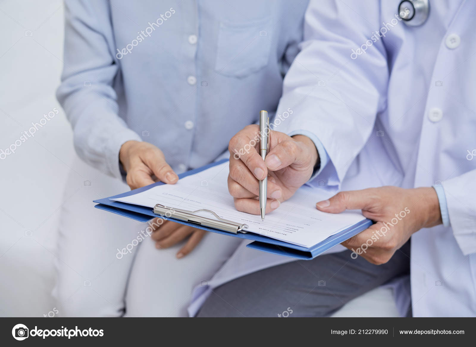 Doctor Holding Clipboard Hands While Helping Senior Patient Fill ...