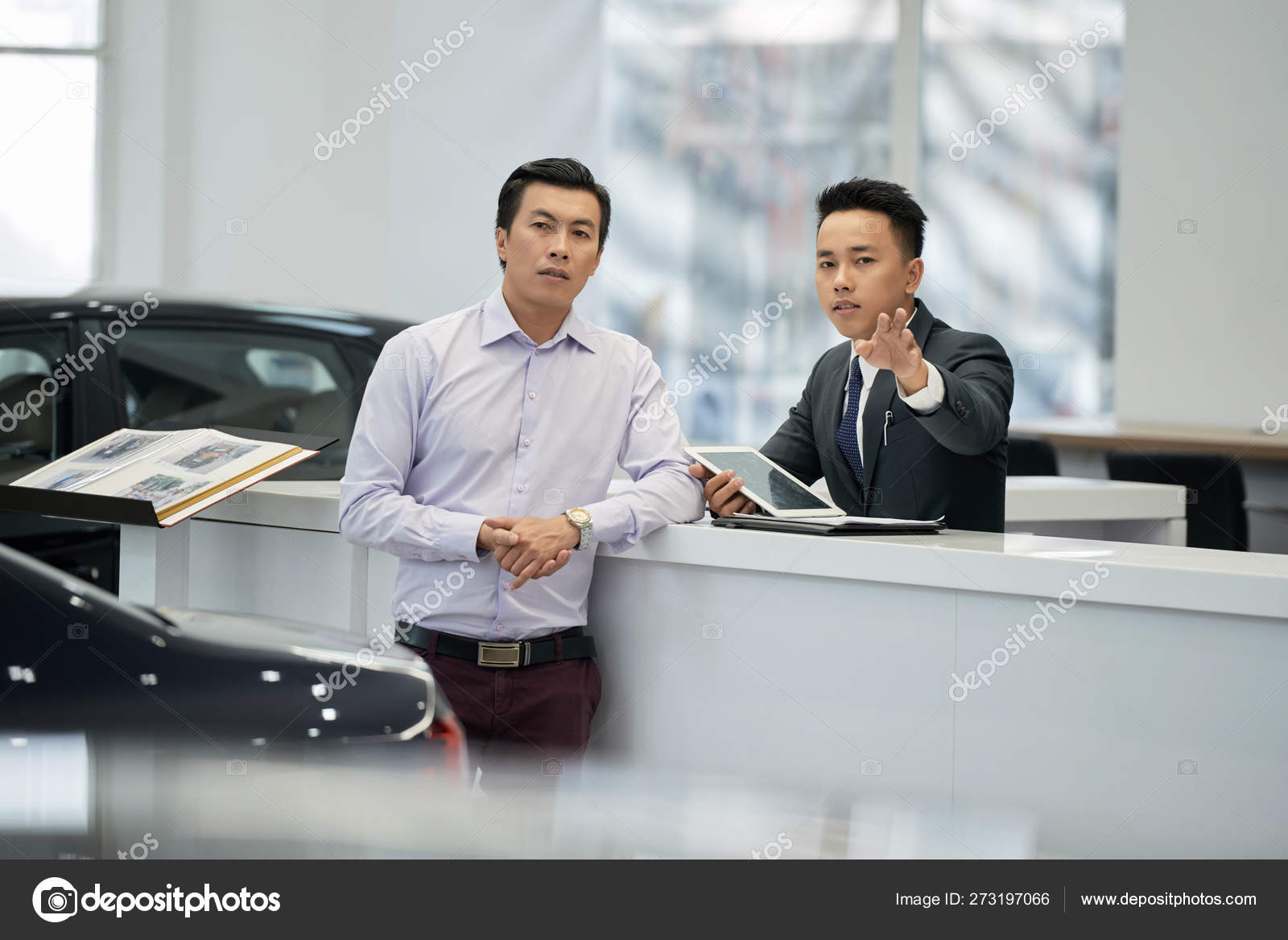 Car Dealership Managers Helping Client Find New Car According His Stock ...