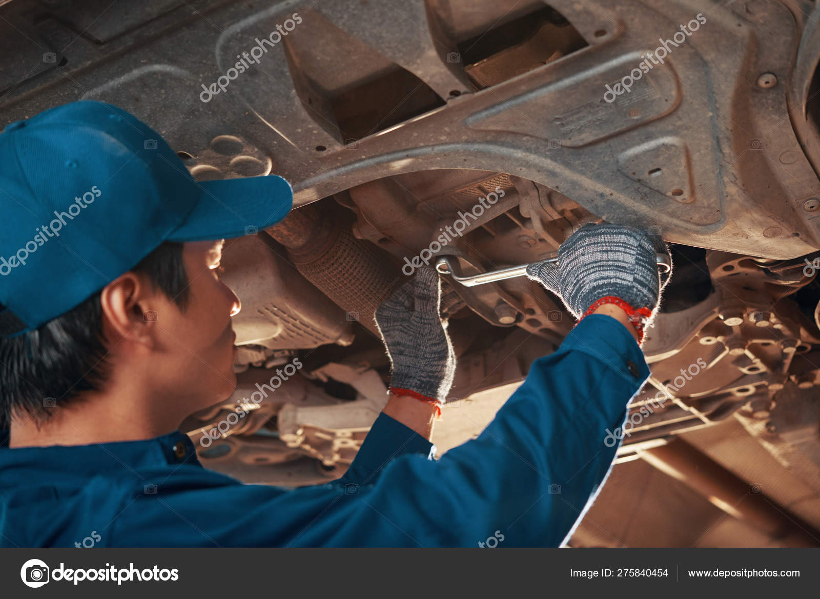 Car Mechanic Tightening Nut Spanner Car Bottom Stock Photo by ...