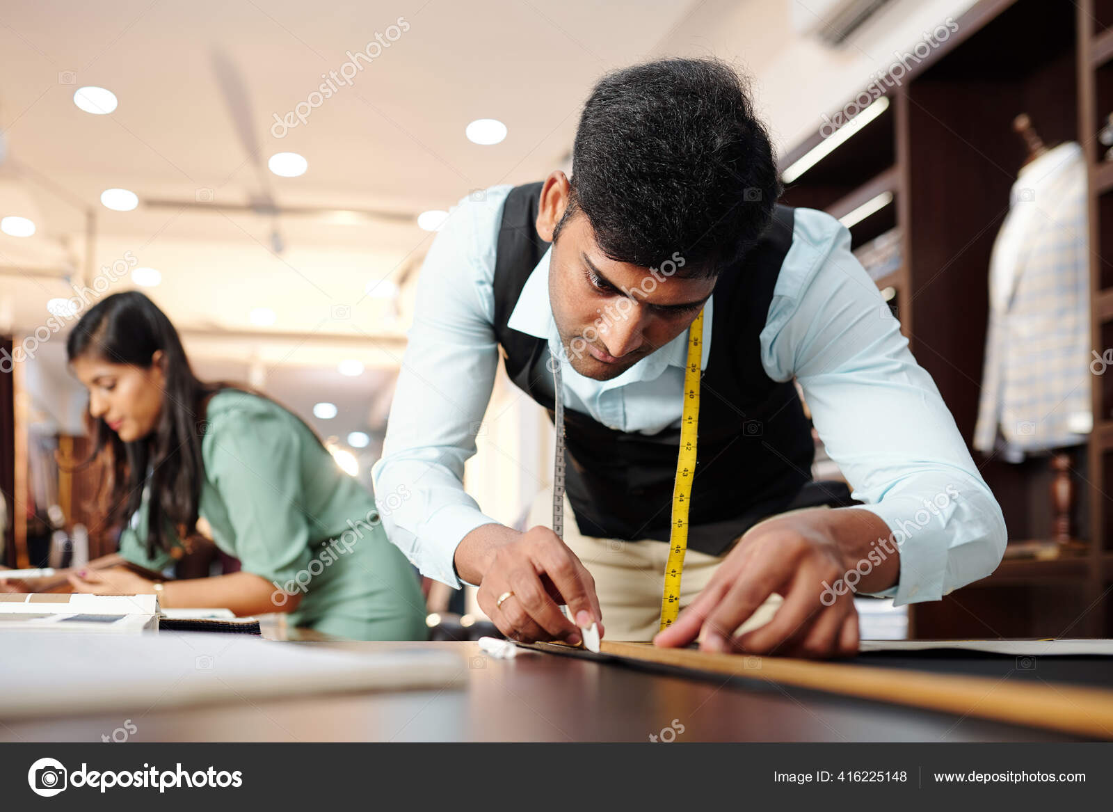 Young Indian Tailor Cutting Out Details Jacket His Colleague Working ...