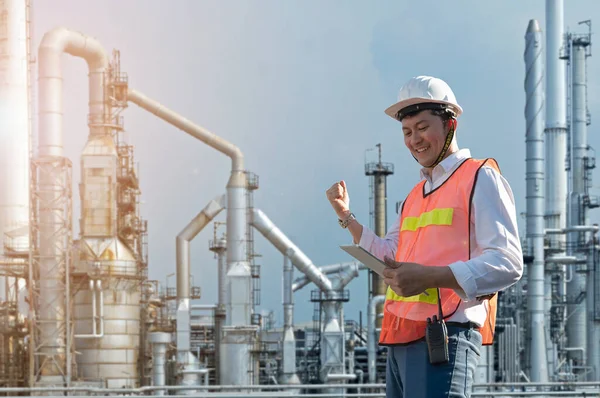 oil tank reinfery factory and Asian worker staff engineer hold tablet - Stock Image - Everypixel