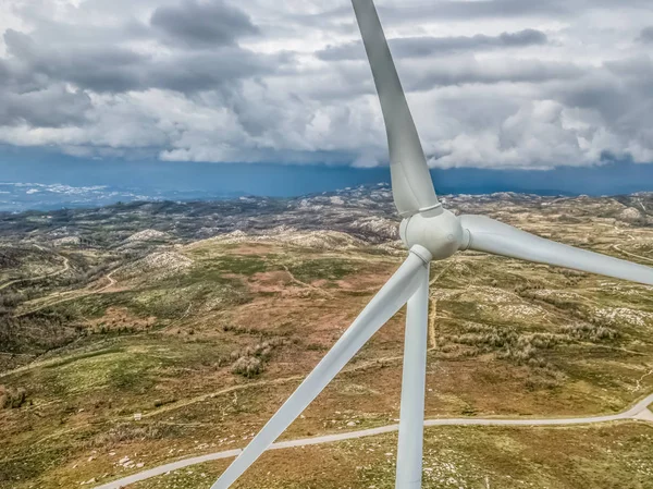 Detailed aerial view, by drone, of a wind turbines on top of mountains ...