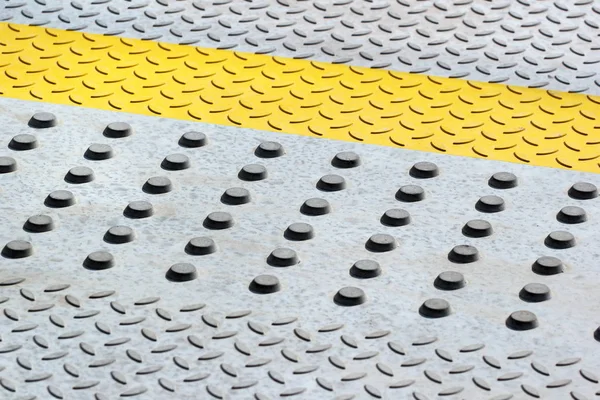 Worn safety bumps on yellow painted metal floor Stock Photo by ©Tarkus ...