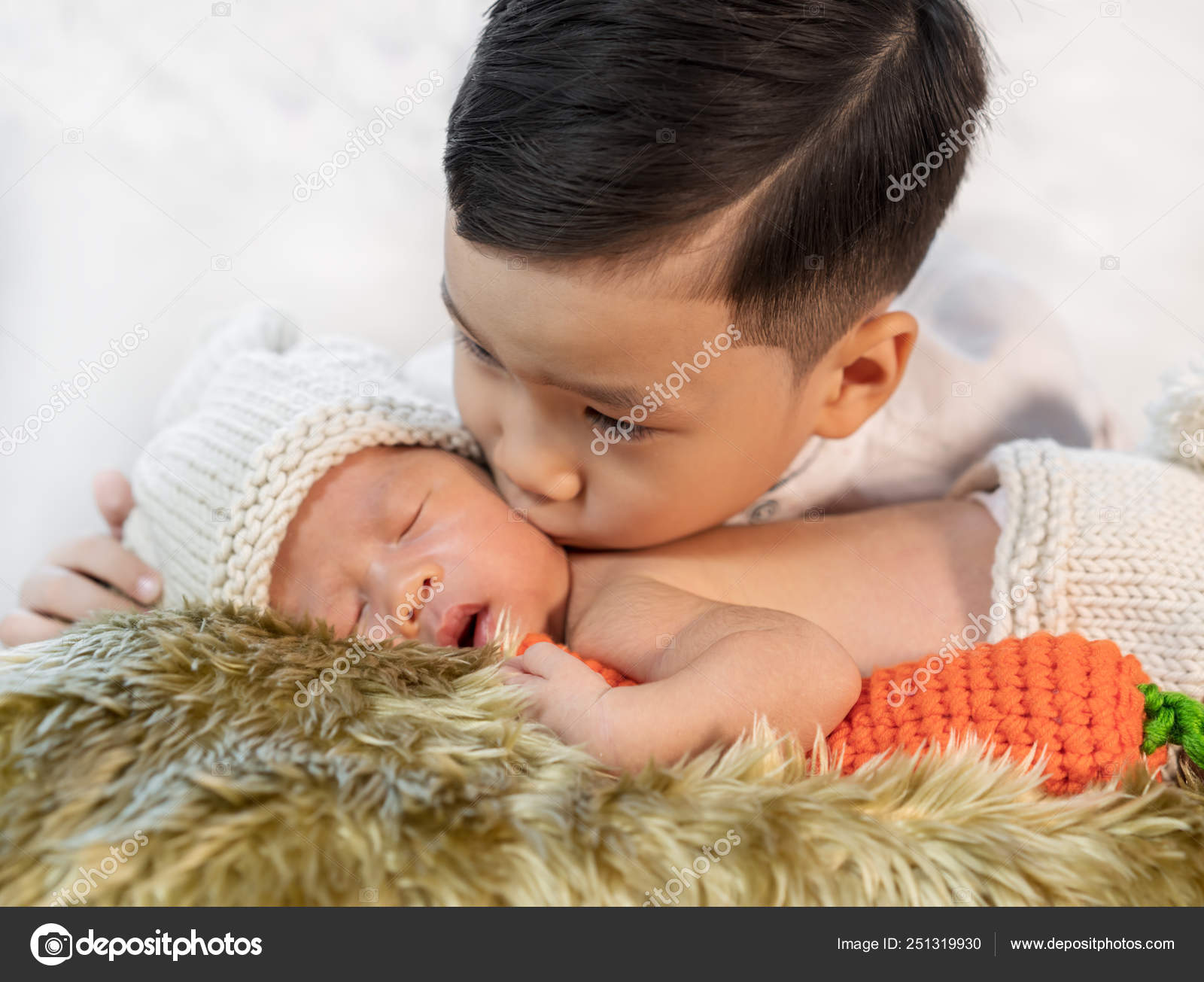 Boy kissing his newborn baby brother — Stock Photo © geargodz #251319930
