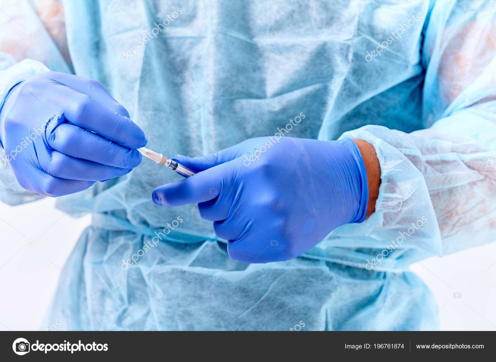 Doctor using a syringe in a hospital during a surgical operation on ...
