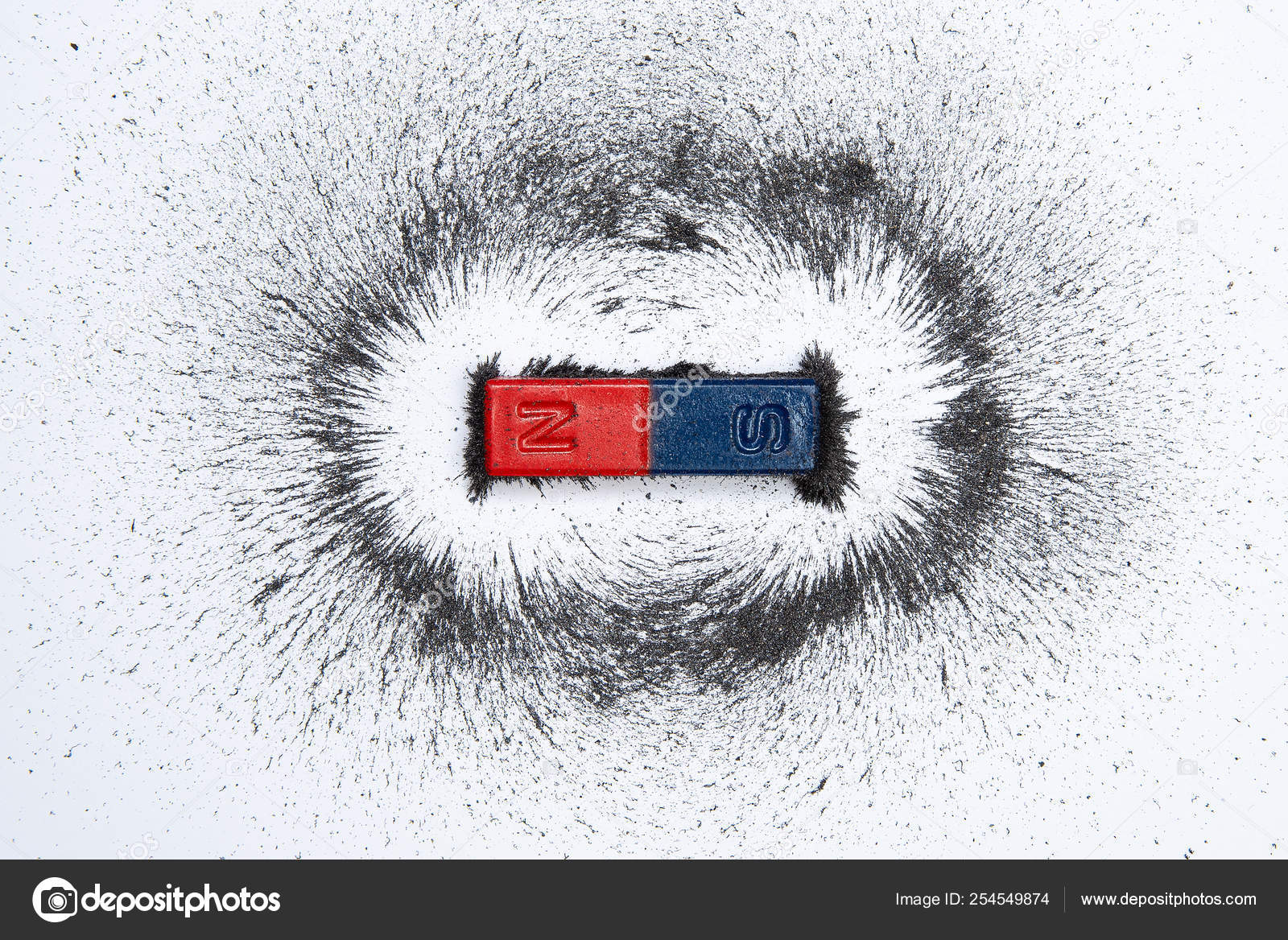 Bar magnet with iron powder magnetic field on white background. Science ...