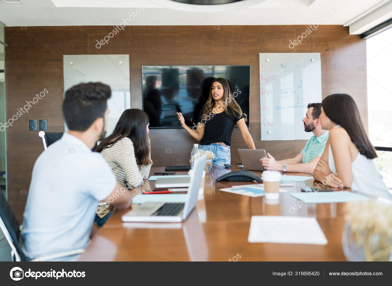 Female Presenter Explaining Colleagues Meeting Workplace Stock Photo by ...