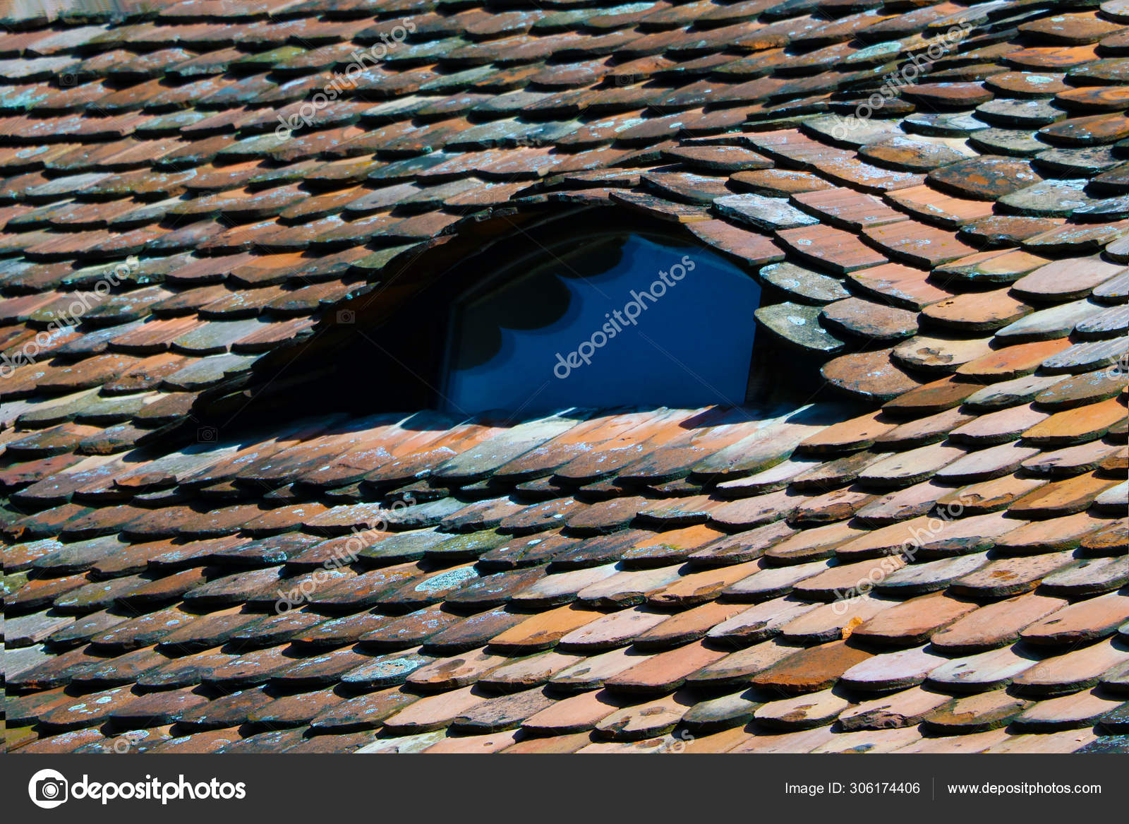 Old skylights from the red roof tiles of a house in the old part of the ...