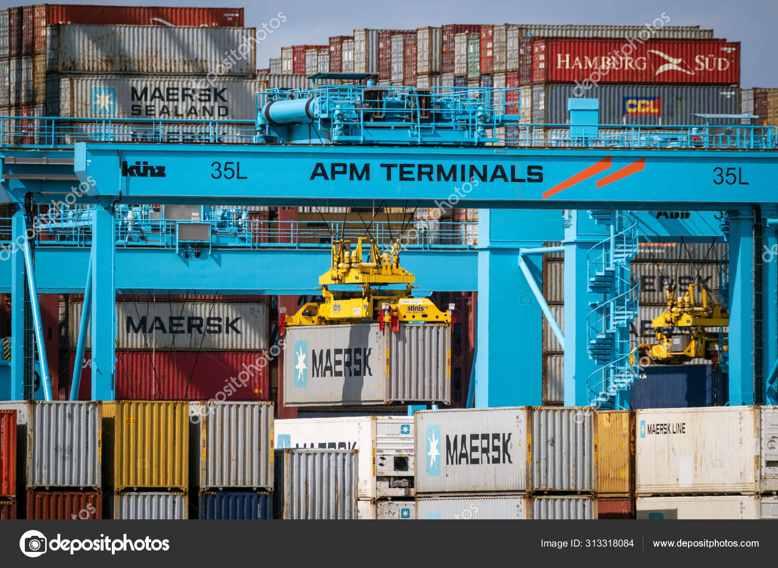 Shipping containers are moved in the APM Terminal in the new Maa ...