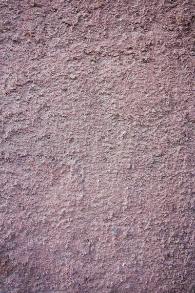uneven pink plaster covered shabby old wall, horizontal cracked ...