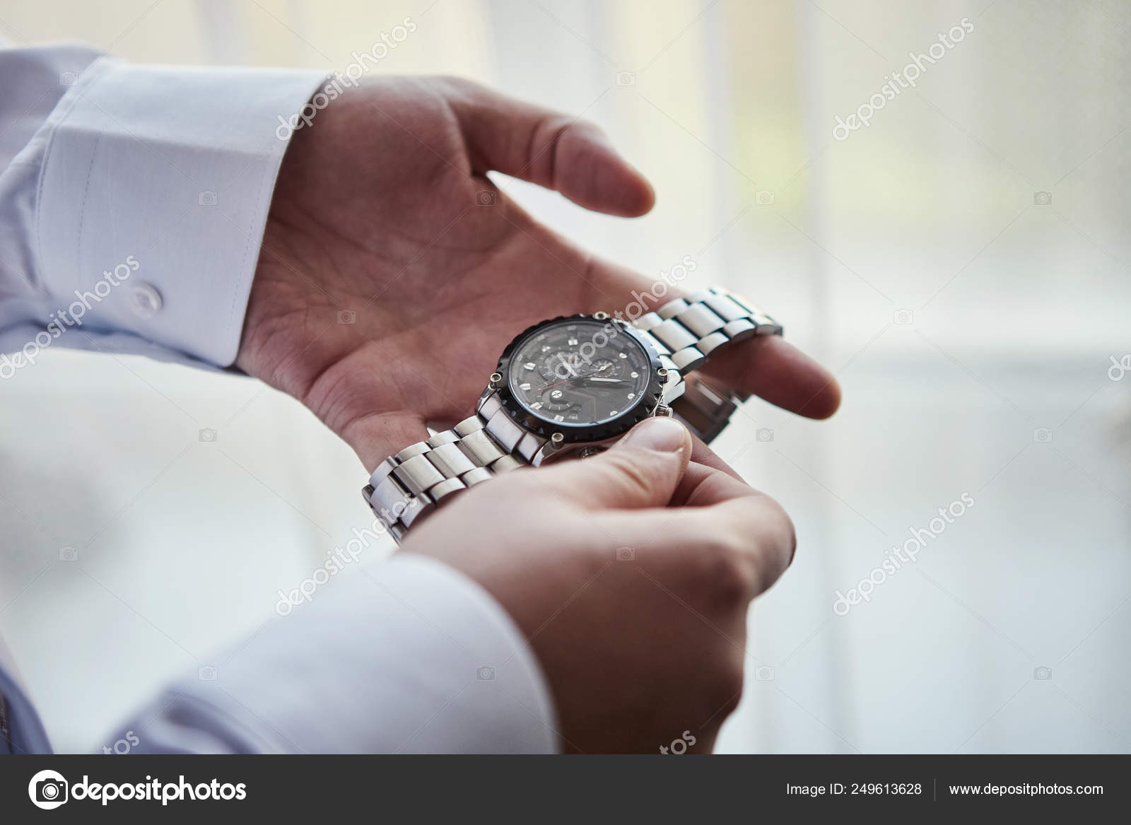 Businessman checking time on his wrist watch, man putting clock on hand ...